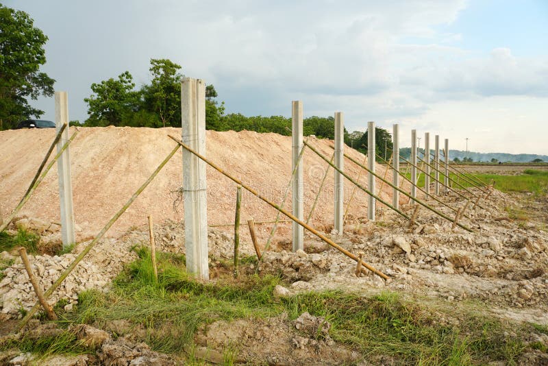 Precast Concrete I-beams are Placed in Rows To Form a Fence Wall ...