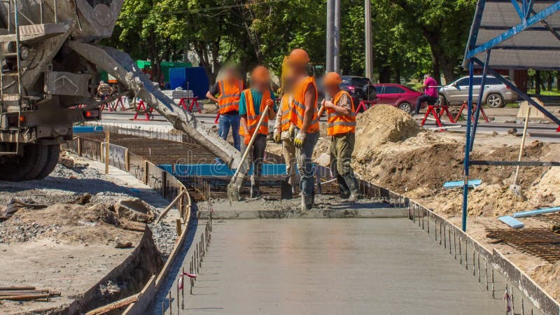 Concrete Leveling Workers on Construction Site with a Mix Trowel ...