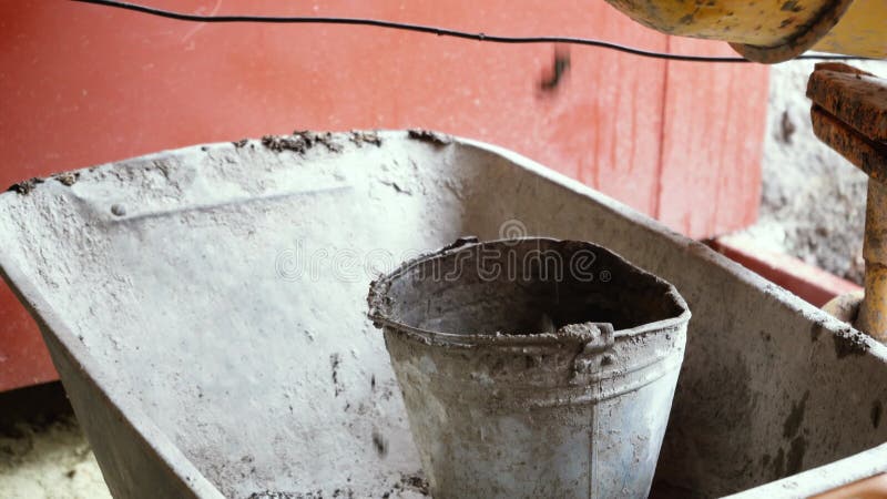 The Concrete Mixer Mixes the Building Mix and Pours it into a Bucket ...