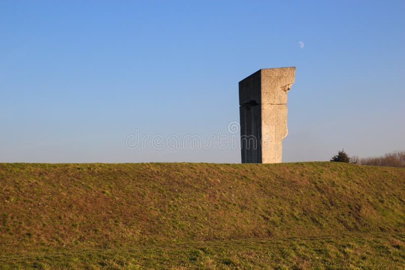The Concrete Monument on the Background of Green Grass and Sky Stock ...