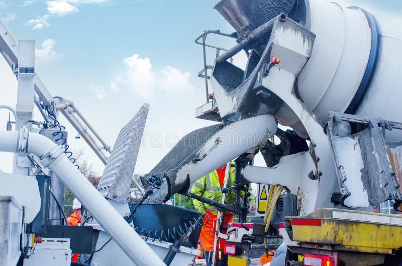Concrete is Offloaded from a Concrete Mixer into a Concrete Pump ...