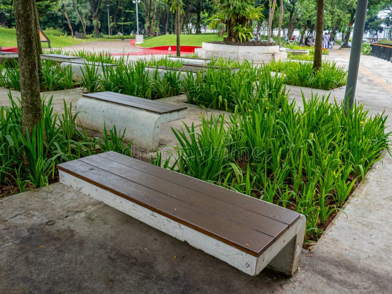 A Concrete Park Bench with Wooden Sitting Pad Stock Image - Image of ...