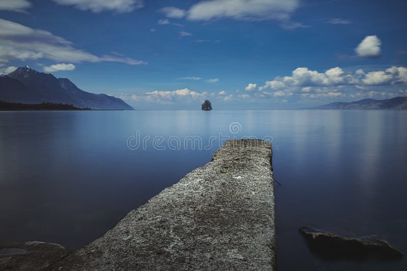 Concrete Pathway in the Lake with a Cloudy Blue Sky in the Background ...