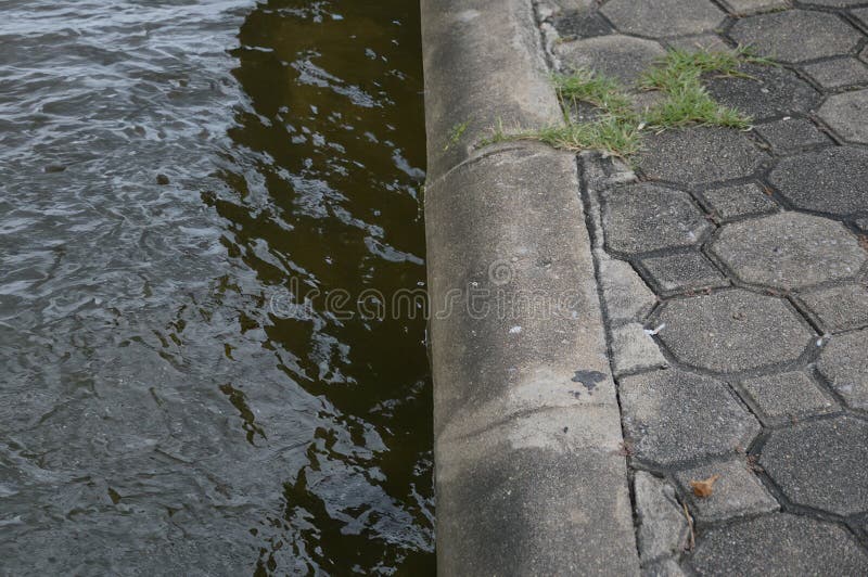 Concrete Pavement with a Small River Stock Photo - Image of reflection ...