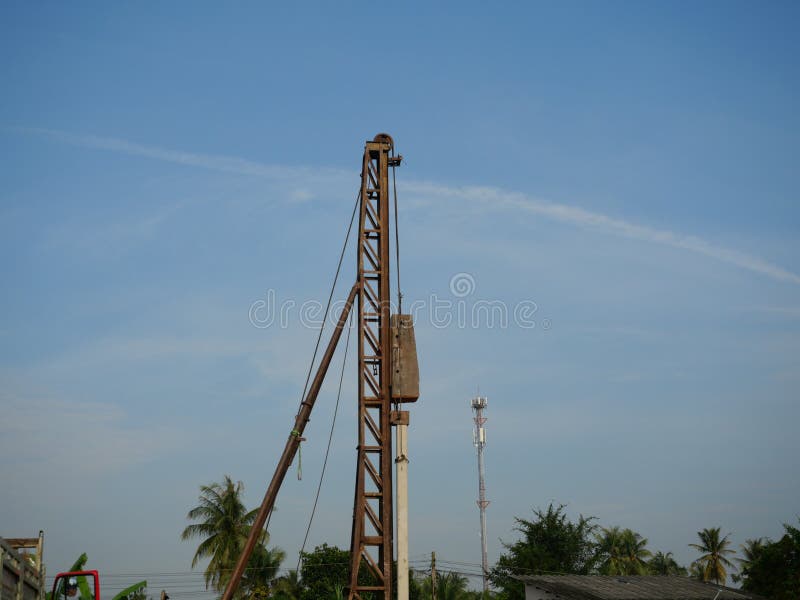 Concrete Pile is Being Driven into the Ground at Construction Site ...