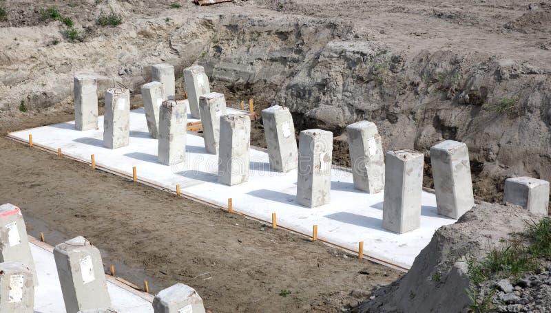Concrete Piles Foundation for a New Building on Construction Site Stock ...