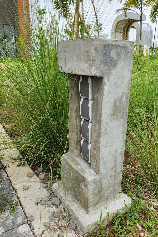 A Concrete Pillar with Recessed Electrical Outlets in a Park or Garden ...