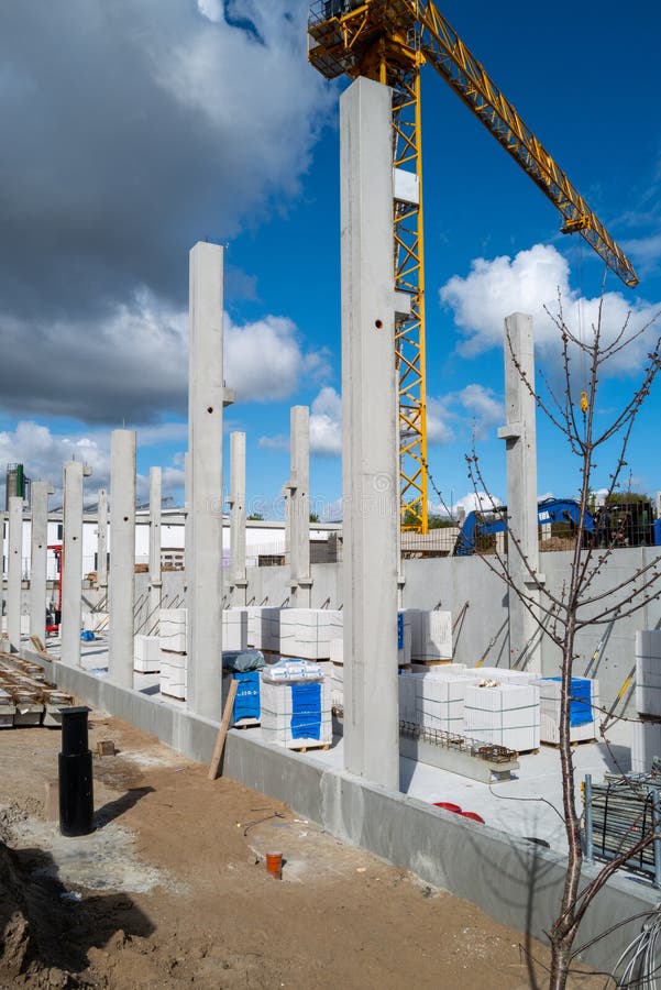 Concrete Pillars for a Factory Building are Erected on a Construction ...