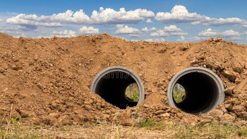 Concrete Pipes, Buried Earth and Sky. Stock Photo - Image of piled ...