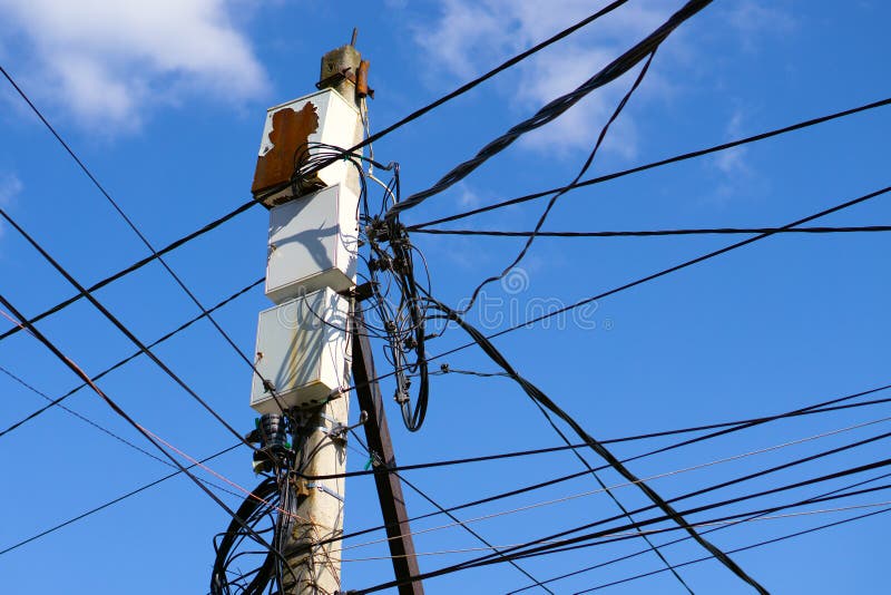 Concrete Pole with Many Wires and Junction Boxes Against the Sky Stock ...