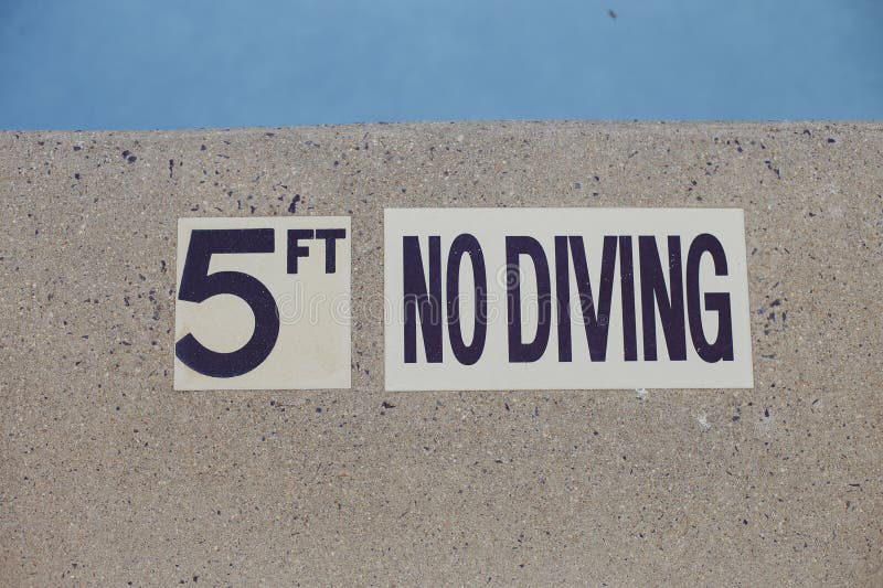 A Concrete Five Foot No Diving Warning Sign Located at the Swimming ...