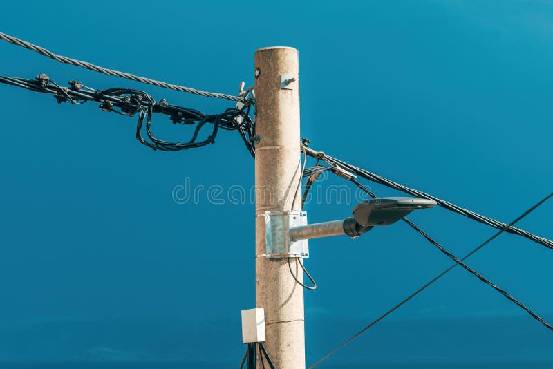 Concrete Post with Overhead Electrical and Telephone Wires and Cables ...