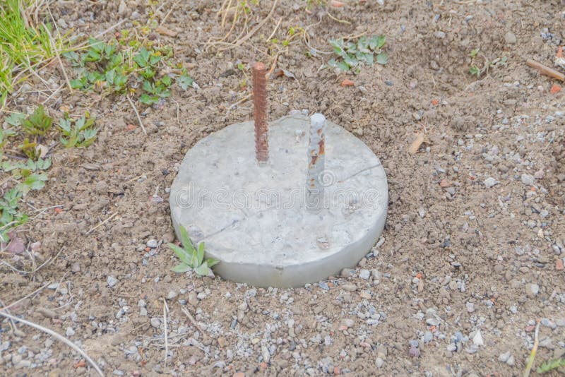 Concrete Post with Rebar for Building a House is Driven into the Ground ...