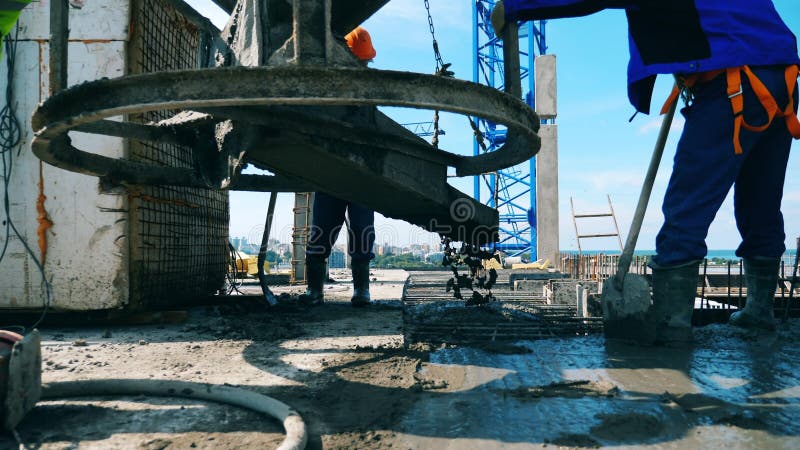 Concrete is Pouring from the Machine Under Worker`s Control Stock Video ...