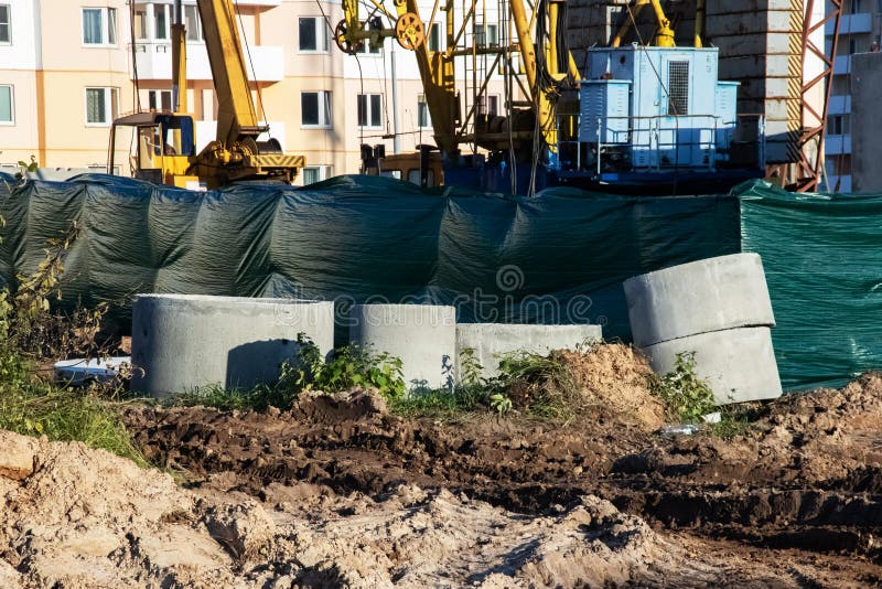 Concrete Rings and Machinery at Construction Site Stock Photo - Image ...