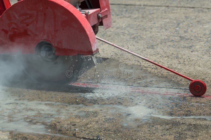 Concrete Road Cutters with Worker. Worker Using Diamond Saw Blade ...