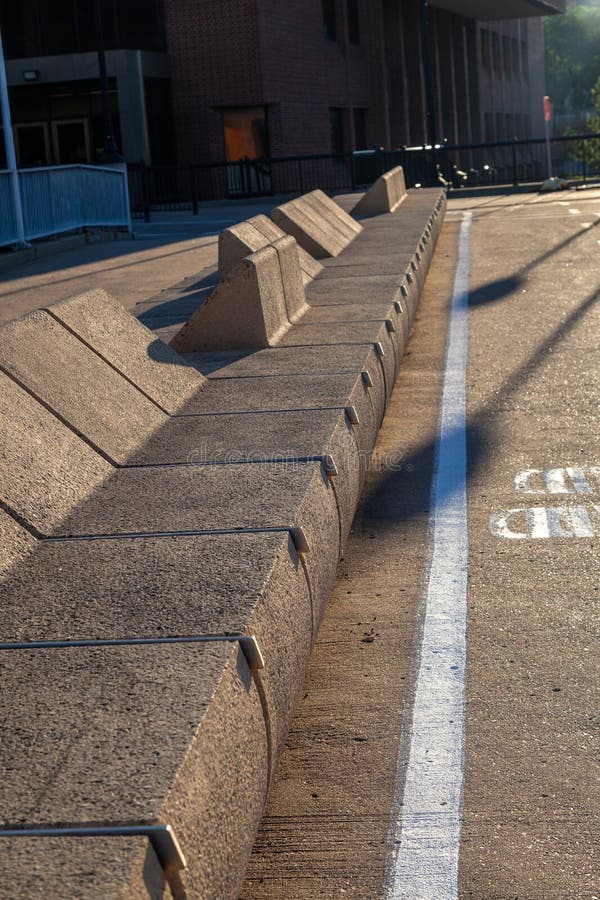 Concrete Seats Act As a Barrier between the Sidewalk and a Bike Path in ...