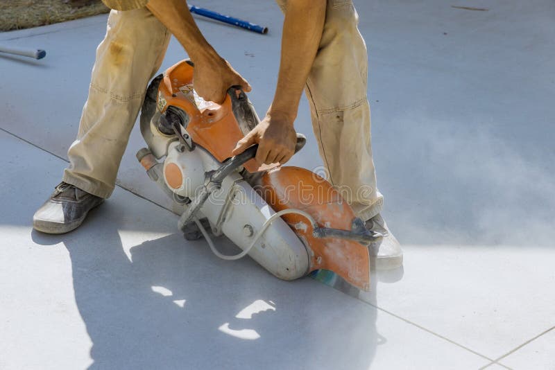 Concrete Sidewalk is Cut Using a Diamond Blade Saw by a Construction ...