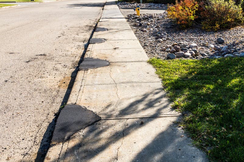Concrete Sidewalk Repair with Asphalt Patching Stock Photo - Image of ...