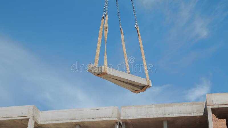 Construction Site with Crane Lifting Concrete Slab. a Dynamic View of a ...