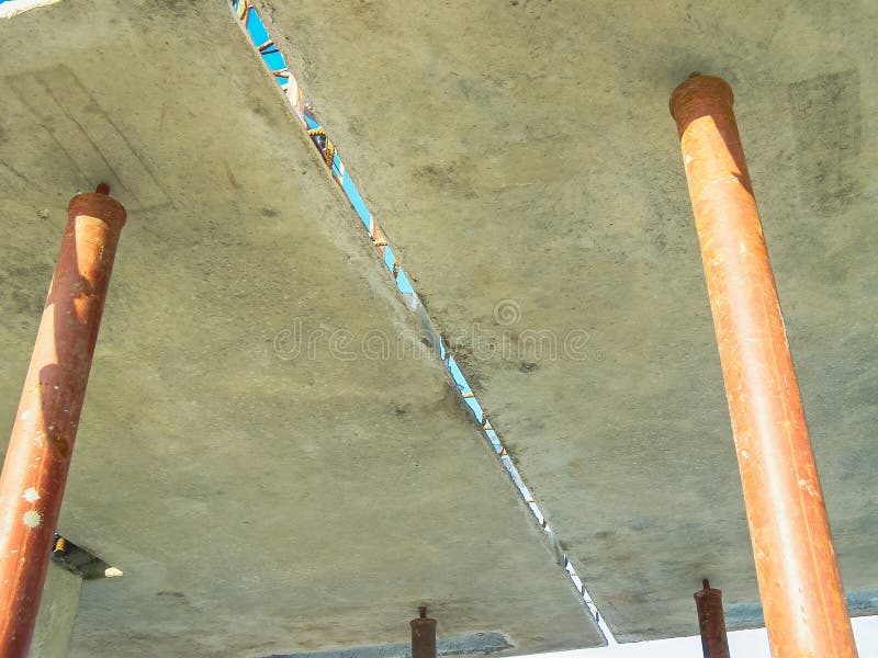 Concrete Slab Supported by Rusty Metal Columns Seen from a Unique ...