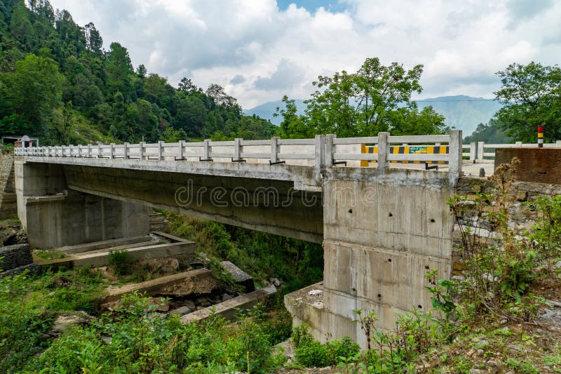 A Concrete Solid Slab Bridge Connecting Two Small Hills at the Base in ...