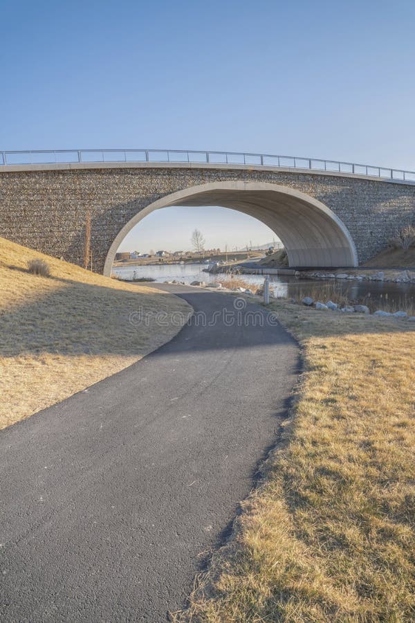 Concrete Trail in the Middle of a Grass with a View of an Arched Bridge ...