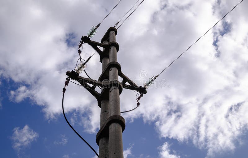 Concrete Utility Pole with Green Insulators Under a Cloudy Sky Stock ...
