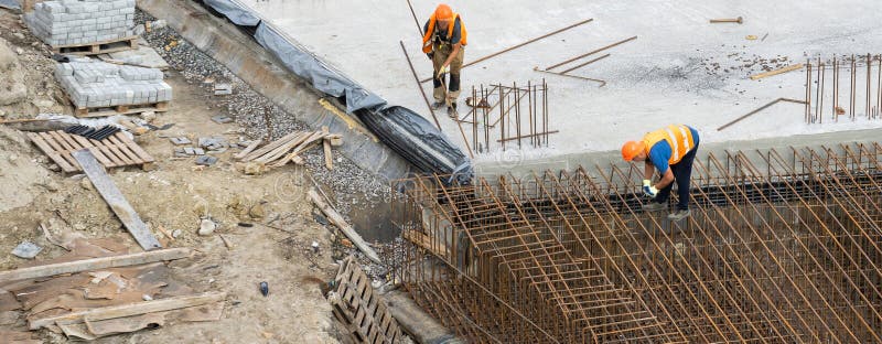 Concreting Work: Construction Site Worker during Concrete Pouring into ...