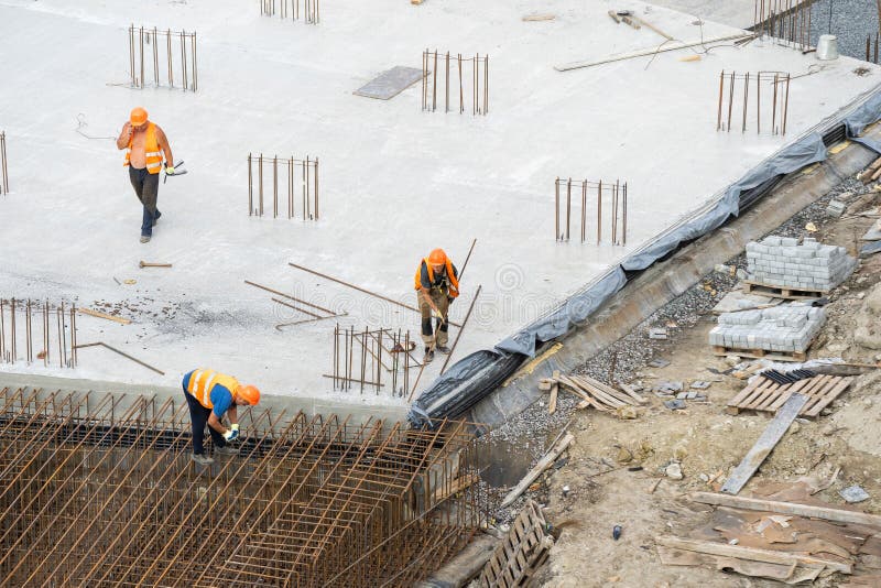 Concreting Work: Construction Site Worker during Concrete Pouring into ...