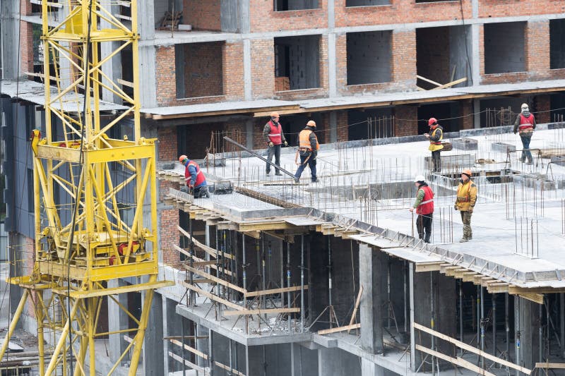 Concreting Work: Construction Site Worker during Concrete Pouring into ...
