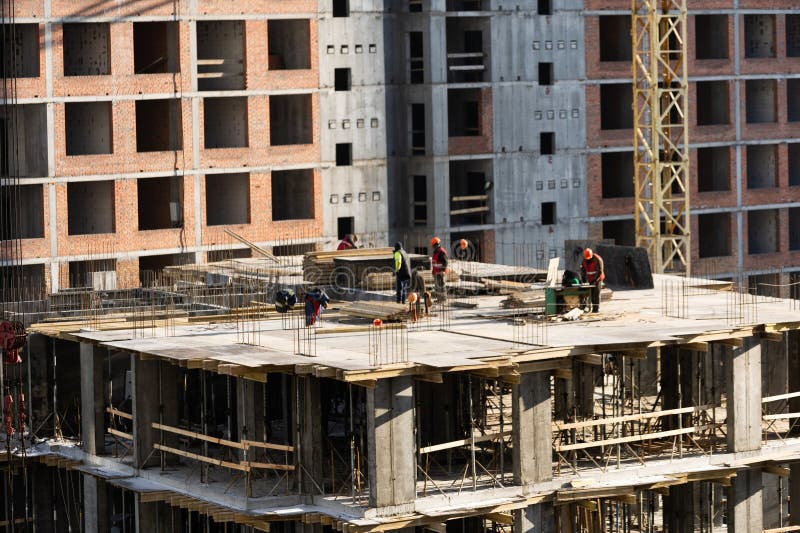 Concreting Work: Construction Site Worker during Concrete Pouring into ...
