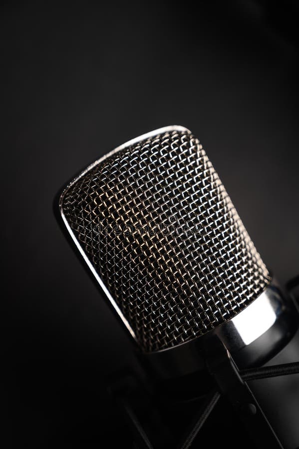 Black Studio Microphone on a Black Background with a Pop Filter with ...