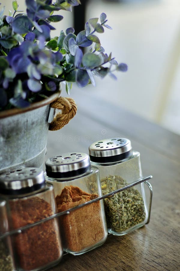 Condiment Set with a Vase of Flowers on the Table Stock Image - Image ...