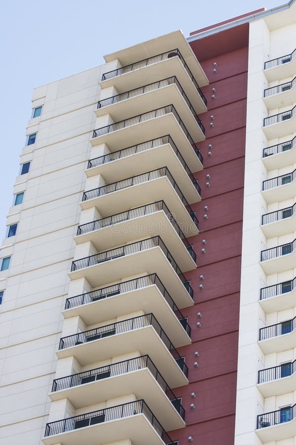 Condo Balconies by Red Stone Wall Stock Photo - Image of residence ...