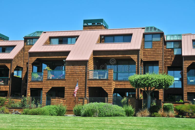 Condo building with grass stock image. Image of building - 10705639