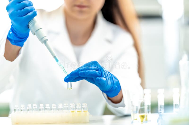 Conducting Chemical Research in a Research Laboratory. Pipetting the ...