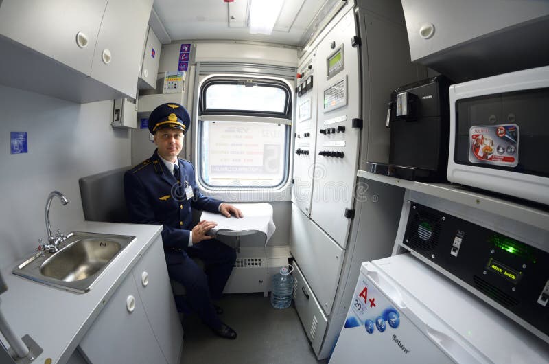 Conductor Man Sitting in Front of a Window at the Service Compartment ...