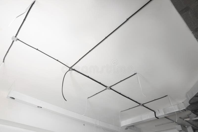 Conduits with Cables and Ventilation System on White Ceiling, Low Angle ...
