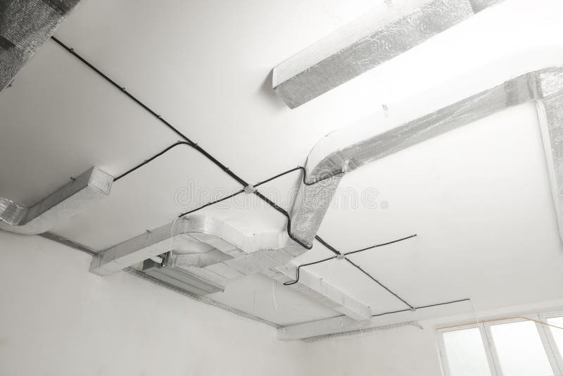 Conduits with Cables and Ventilation System on White Ceiling, Low Angle ...