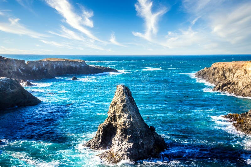 Cone Shaped Rock in the Pacific Ocean Under a Blue Sky Stock Image ...