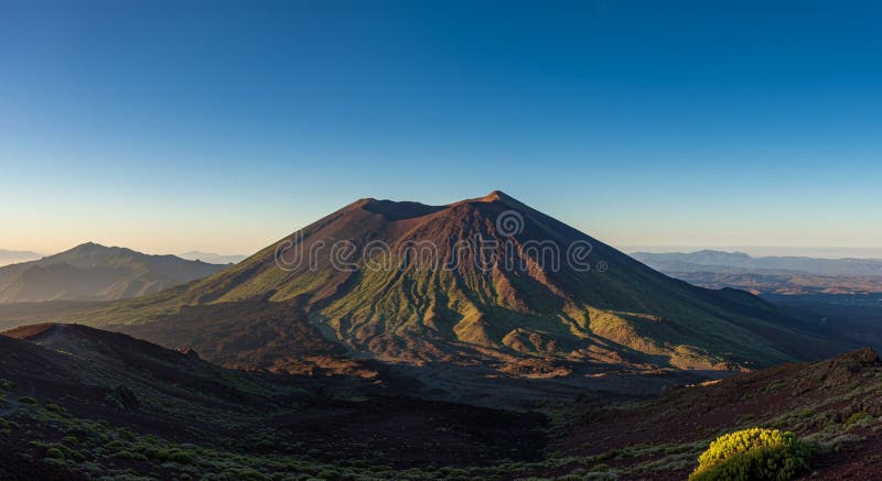 Cone-shaped Volcano with Steep Slopes, Surrounded by Rugged Terrain ...