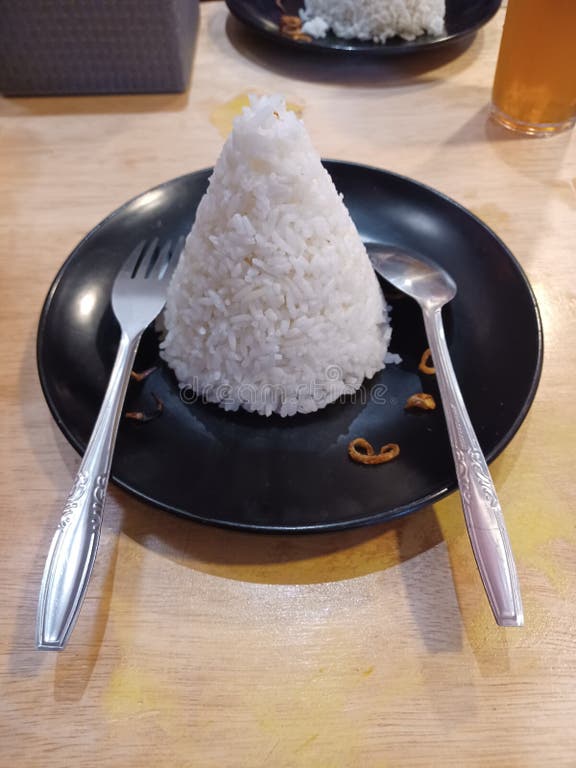 Cone-shaped White Rice with Spoon and Fork Stock Image - Image of ...