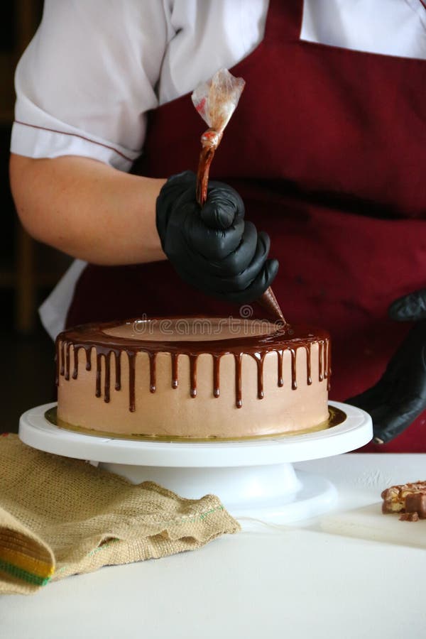 Confectioner Process Chocolate Cake on Table. the Process of Decorating ...