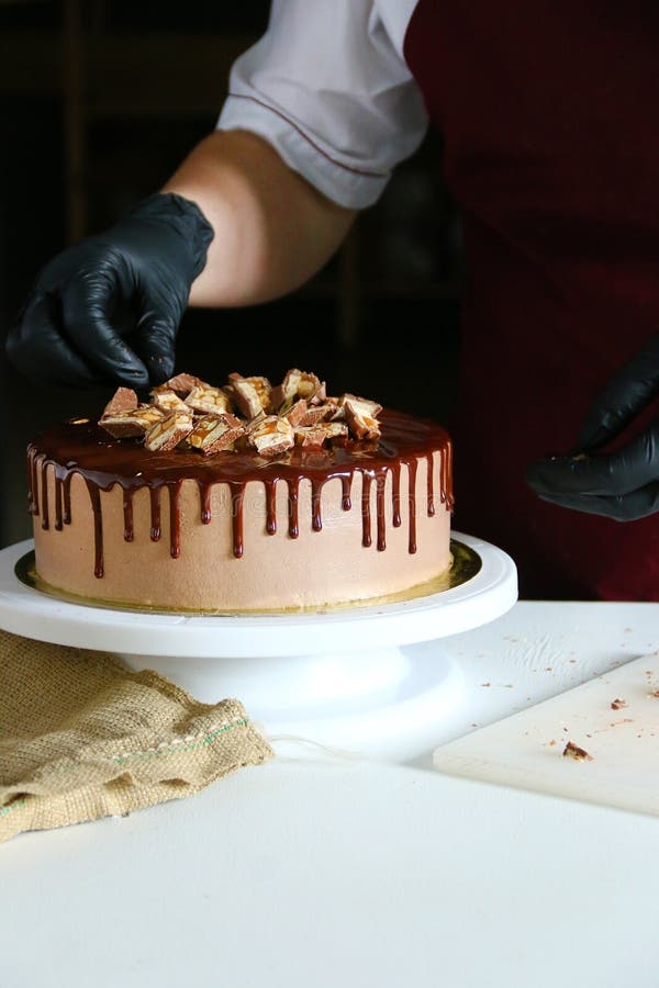 Confectioner Process Chocolate Cake on Table. the Process of Decorating ...