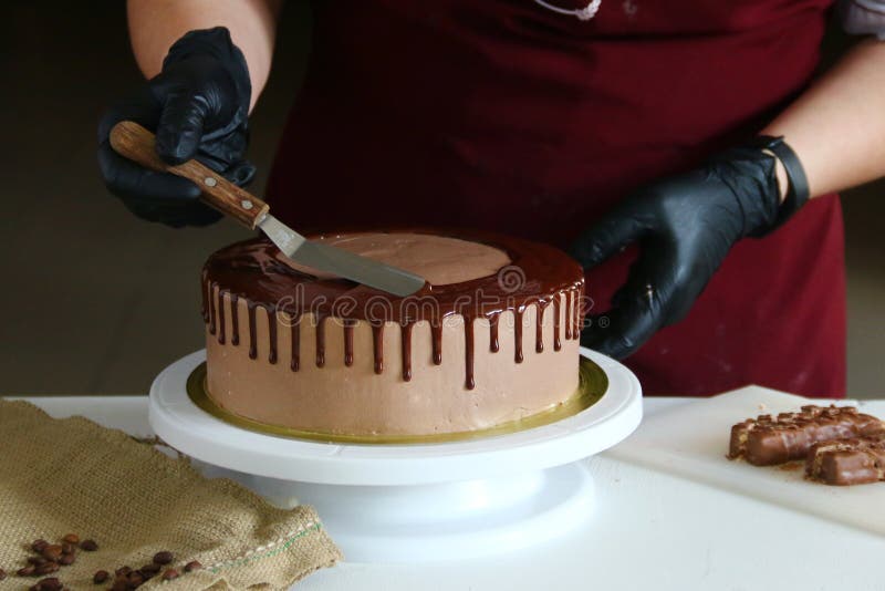 Confectioner Process Chocolate Cake on Table. the Process of Decorating ...