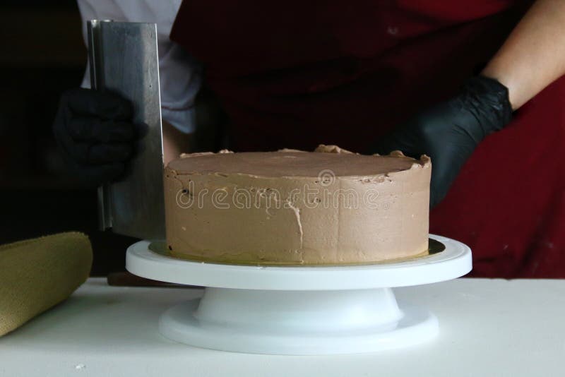 Confectioner Process Chocolate Cake on Table. the Process of Decorating ...