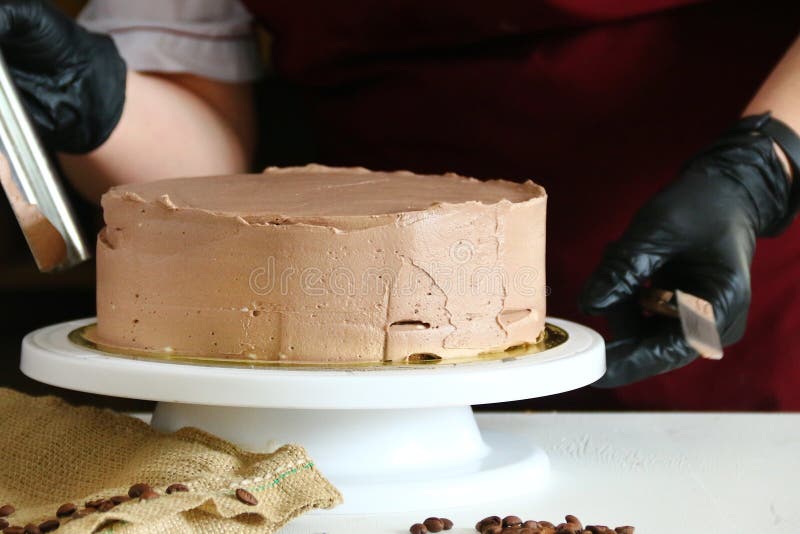 Confectioner Process Chocolate Cake on Table. the Process of Decorating ...