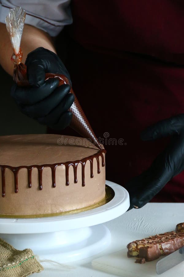 Confectioner Process Chocolate Cake on Table. the Process of Decorating ...