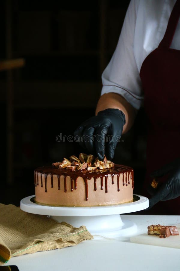 Confectioner Process Chocolate Cake on Table. the Process of Decorating ...